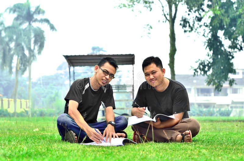 Two Young Student Reading Books Stock Photo - Image of learn, grass ...