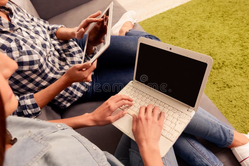 Two Young Students Doing Task and Working on Laptop and Digital Tablet ...