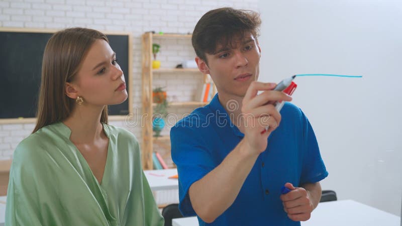 Two Young Students Draw Math Problems on the Glass with a Marker and ...