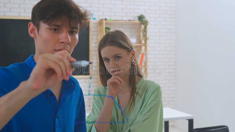 Two Young Students Draw Math Problems on the Glass with a Marker and ...