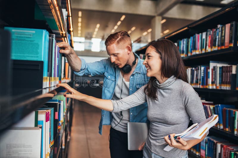 Two Young Students at Library Book Shelf Stock Photo - Image of books ...