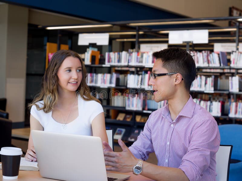Two Young Students at the Library Stock Photo - Image of holding, books ...