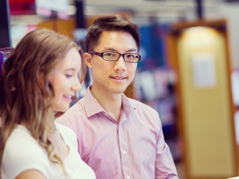 Two Young Students at the Library Stock Photo - Image of books, girl ...