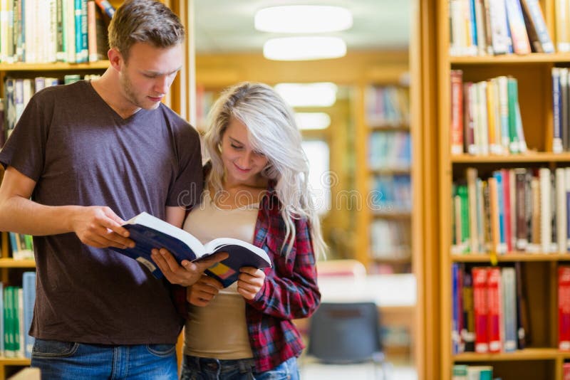 Two Young Students Reading Book in the Library Stock Image - Image of ...