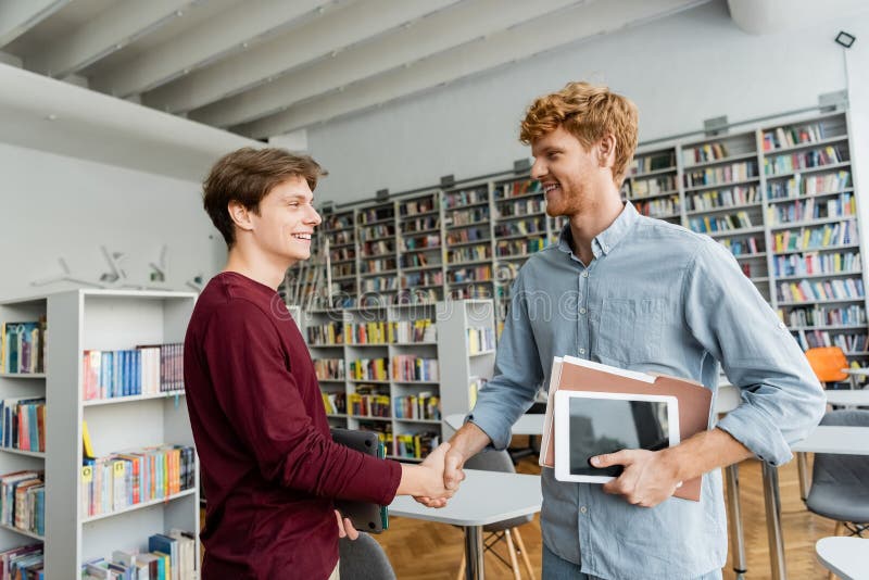Two Young Students Shake Hands in Stock Image - Image of academic ...