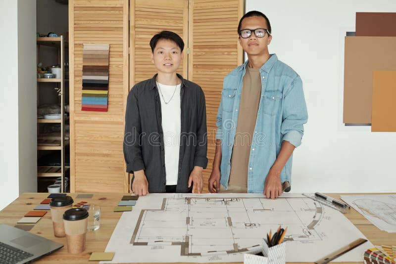 Two Young Successful Engineers Standing by Workplace Stock Photo ...