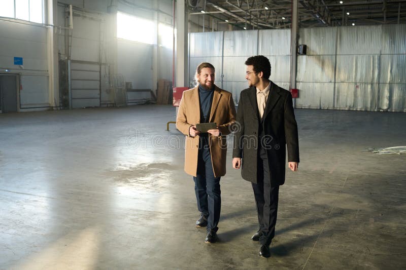 Two Young Successful Entrepreneurs in Elegant Coats Moving Along ...