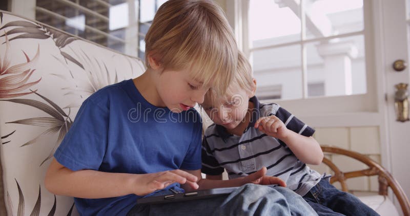 Two Young White Kids Playing with a Tablet Stock Photo - Image of ...