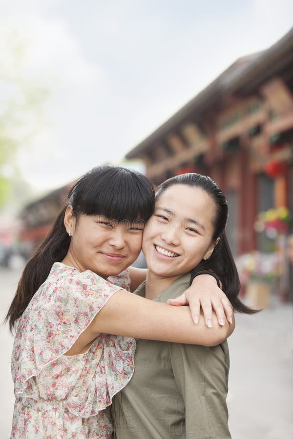 Two young woman embracing stock image. Image of foreground - 33373659