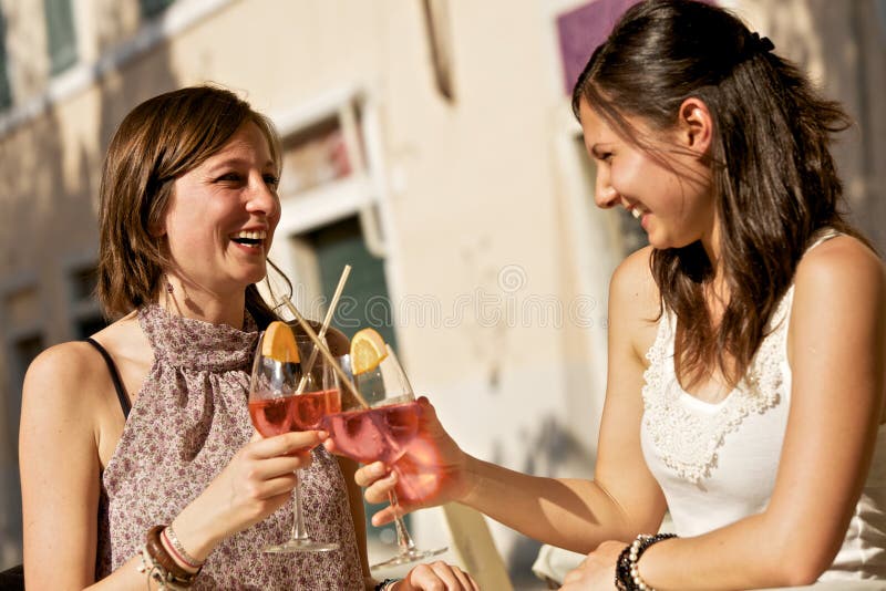 Two Young Women Cheering with Cold Drinks Stock Image - Image of ...