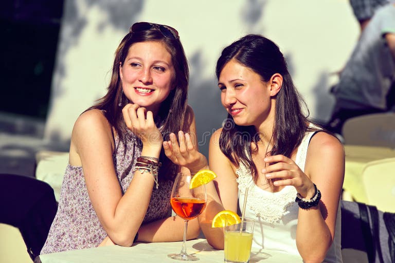 Two Young Women Cheering with Cold Drinks Stock Image - Image of ...