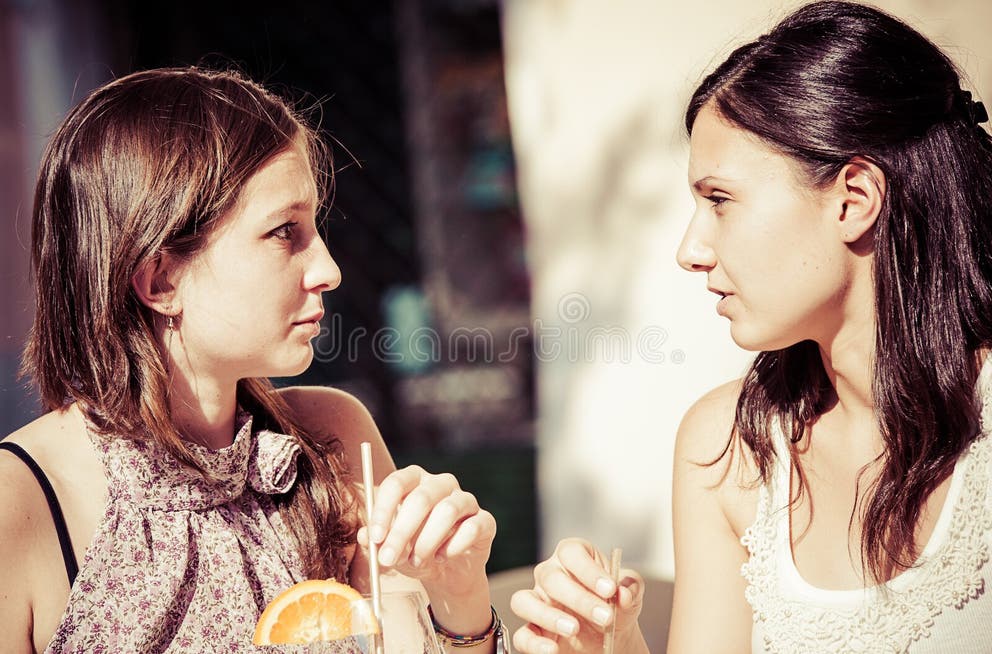 Two Young Women Cheering with Cold Drinks Stock Photo - Image of people ...