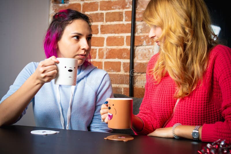 Two Young Women with the Cups of Tea and Coffee Talking Stock Photo ...