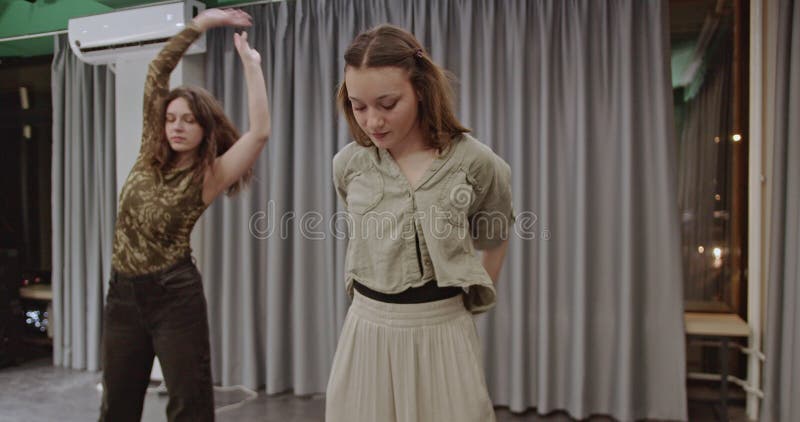 Two Young Women Dance in a Studio, Performing a Contemporary Routine ...