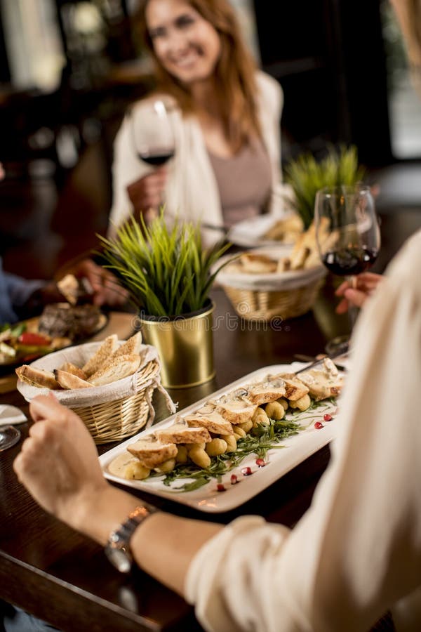 Two Young Women at a Dinner in a Restaurant Stock Photo - Image of ...