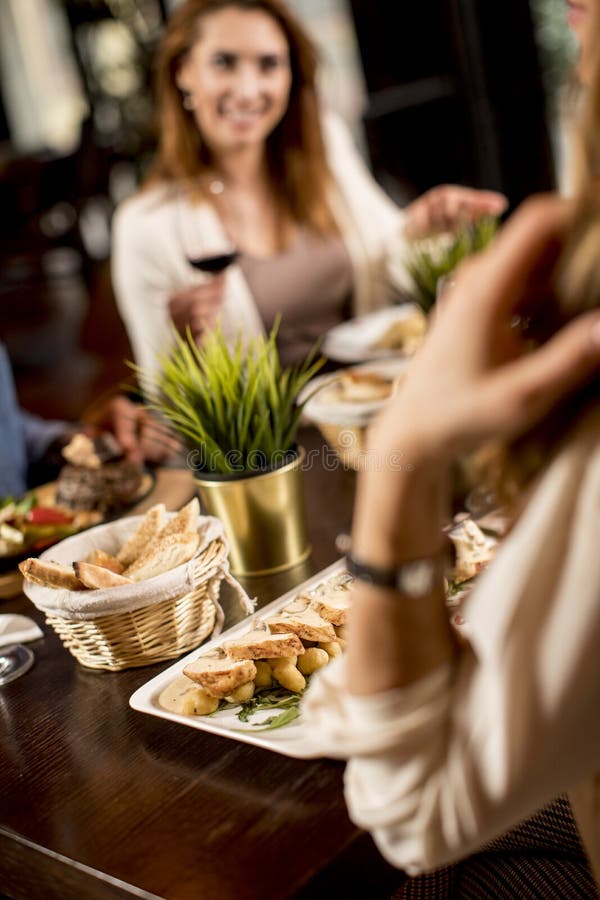 Two Young Women at a Dinner in a Restaurant Stock Photo - Image of ...