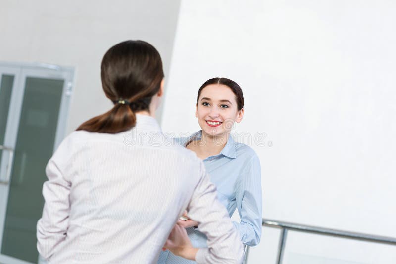 Two Young Women Discuss Documents Stock Image - Image of assistance ...