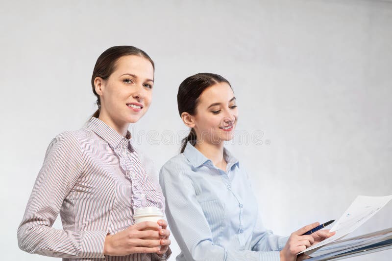 Two Young Women Discuss Documents Stock Photo - Image of meeting ...