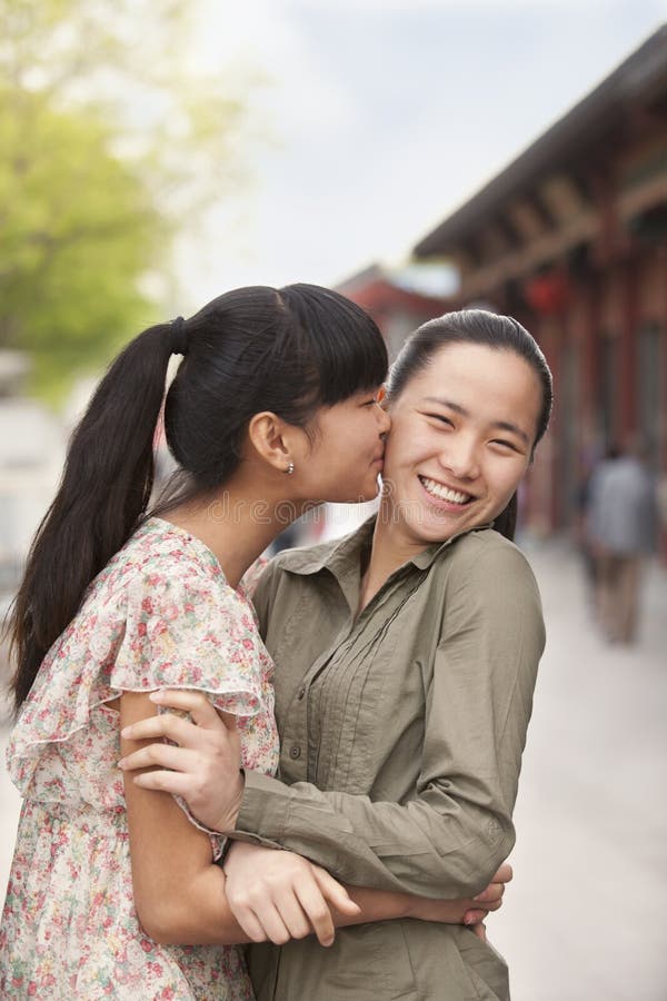 Two young women embracing stock photo. Image of 2024 - 33373668