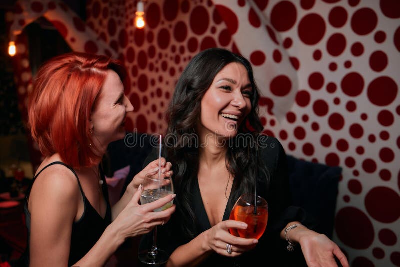 Two Young Women Having Fun in Busy Bar. Stock Image - Image of ...