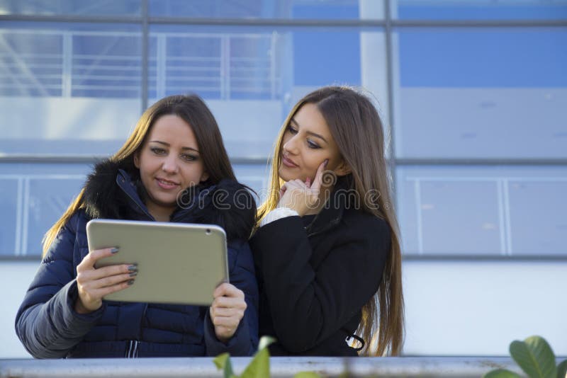 Two Young Women Looking at Tablet Stock Photo - Image of card, look ...