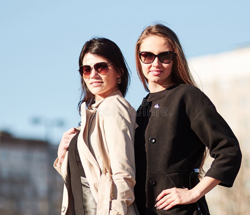 Two Young Women Looking At A Tall Office Building Stock Photo - Image ...