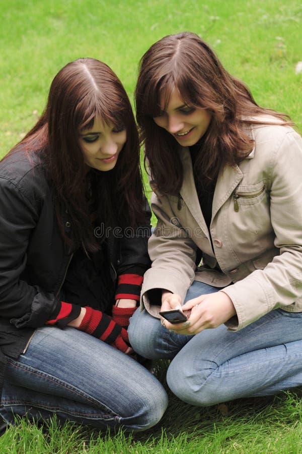 Two Young Women with a Mobile Phone Stock Photo - Image of lady, beauty ...