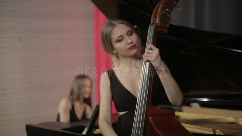 Two Young Women Playing a Musical Instruments Stock Video - Video of ...