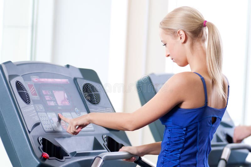 Two Young Women Run on Machine in the Gym Stock Photo - Image of ...