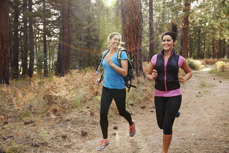 Two Young Women Running in a Forest, Close Up Stock Image - Image of ...