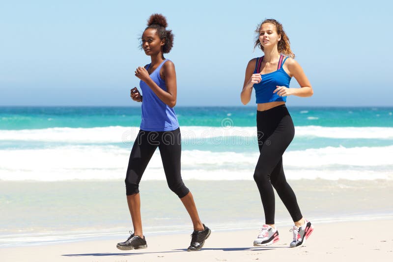 Two Young Women Running by Water on Beach Stock Image - Image of ...