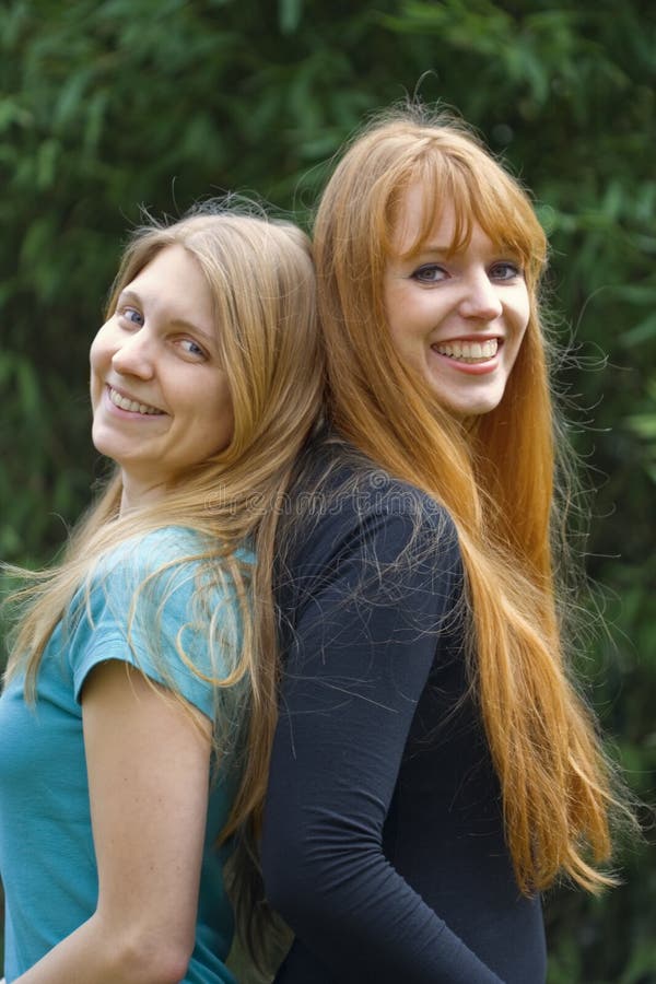 Two Young Women Standing Back To Back Stock Photo - Image of nature ...