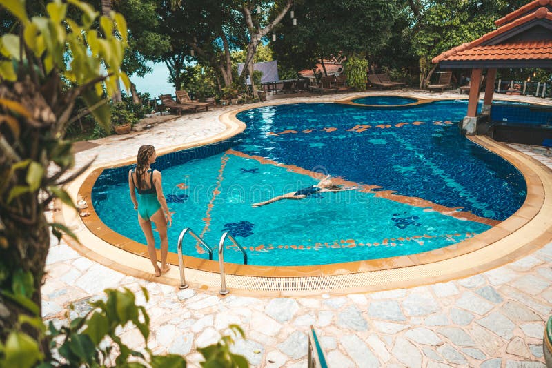 Two Women Swimming in the Swimming Pool Stock Image - Image of alone ...