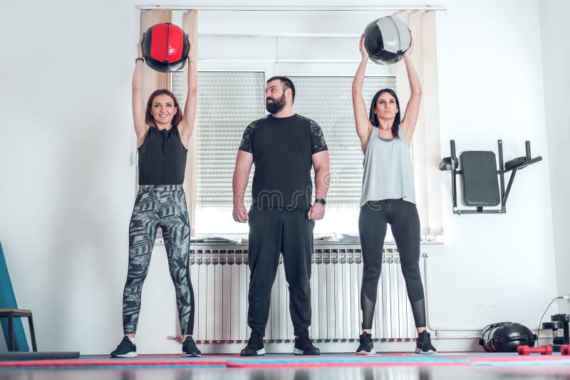 Two Young Women Training at Home with Personal Trainer Stock Photo ...