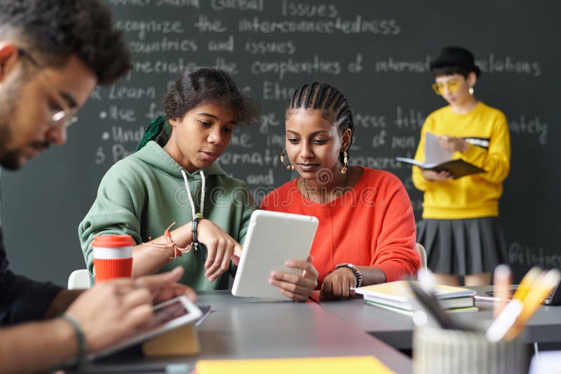 Two Young Women Using Tablet at School Stock Image - Image of classroom ...