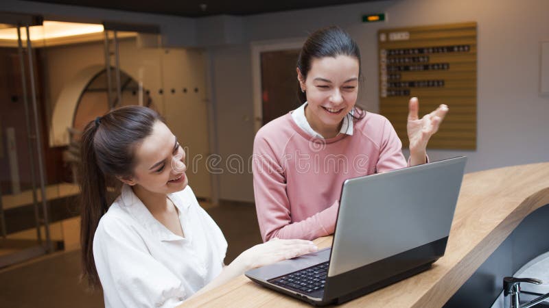 Two Young Women at Work are Engaged in Discussing a Work Project. Stock ...