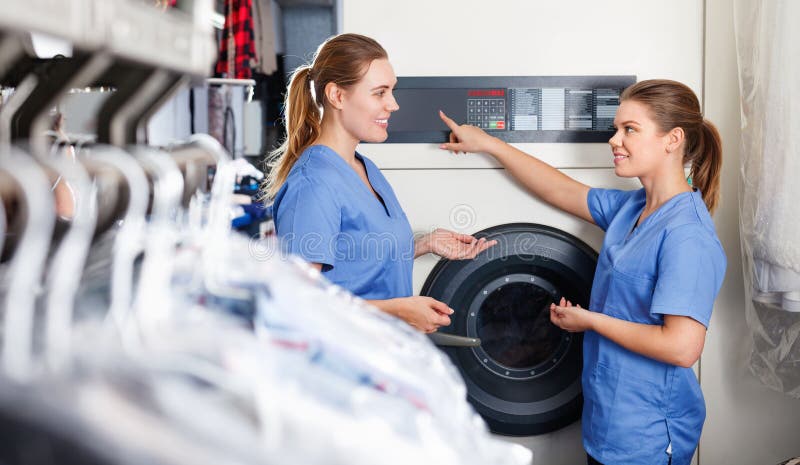 Two Young Women Working in Modern Dry Cleaner Stock Image - Image of ...
