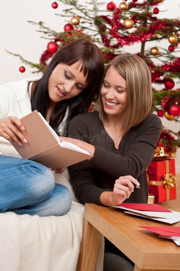 Two Young Women Writing Christmas Cards Stock Image - Image of sofa ...