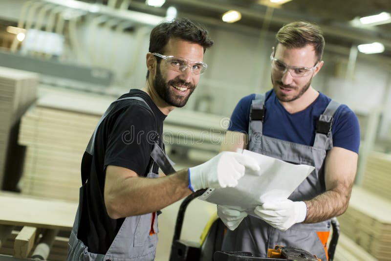 Two Young Workers in the Industry Read Document Stock Photo - Image of ...