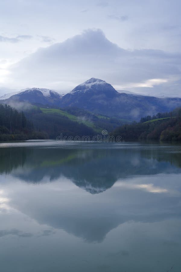 Txindoki with Snow. Mount Txindoki Reflected in the Ibiur Reservoir ...