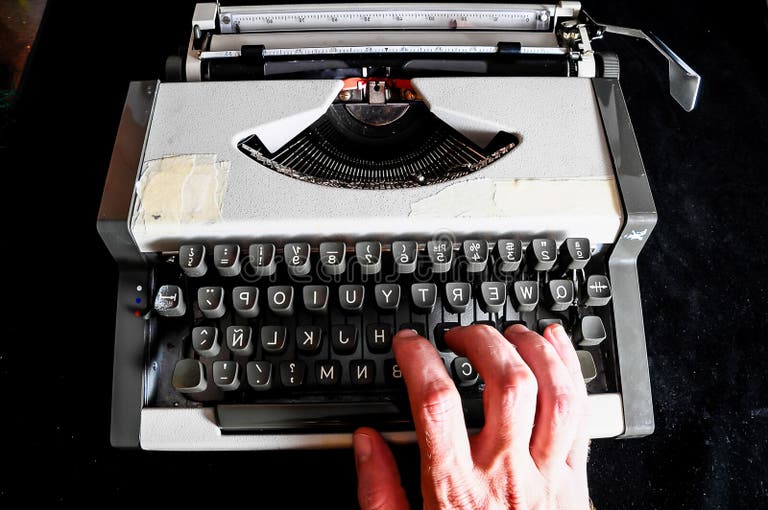 A Typewriter with a Person Typing on it Stock Photo - Image of black ...