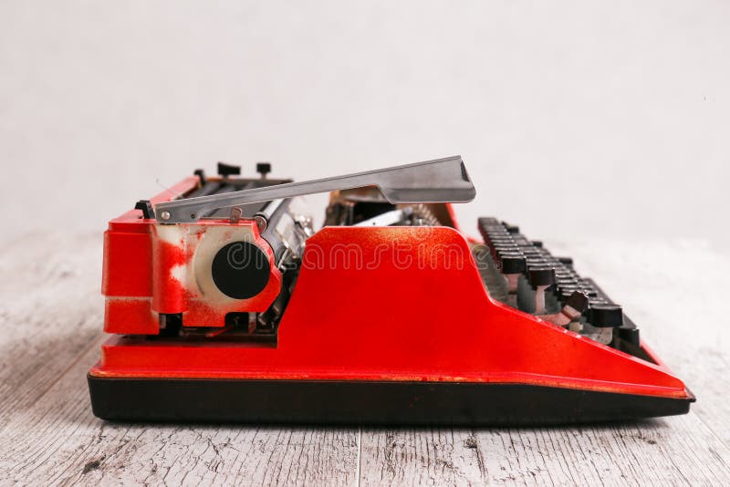The Typewriter is Red with Paper in it and on the Table Stock Photo ...