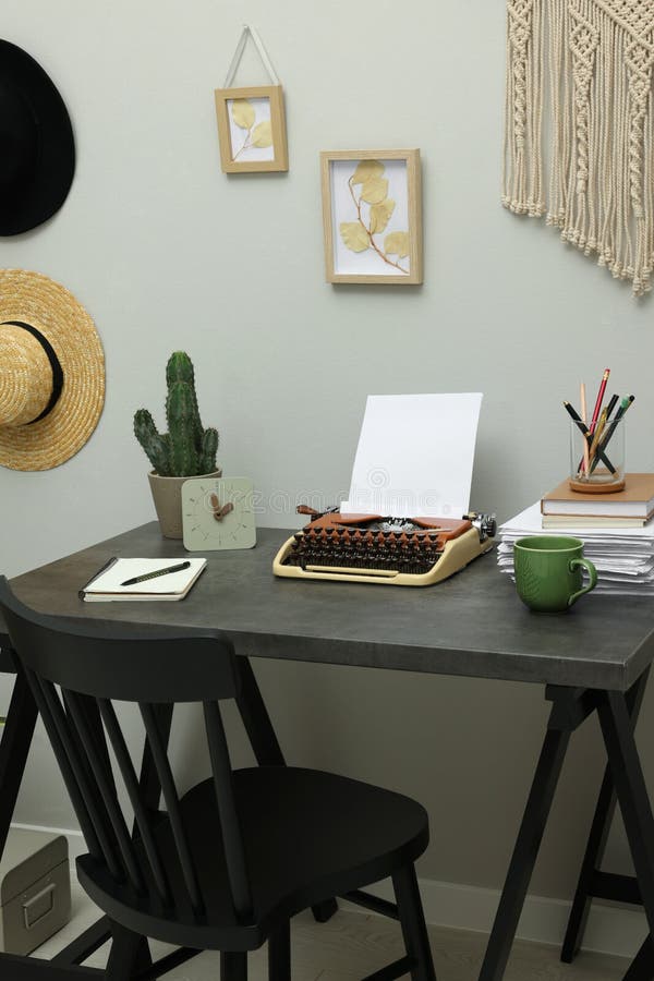 Typewriter and Stack of Papers on Table in Room. Writer`s Workplace ...