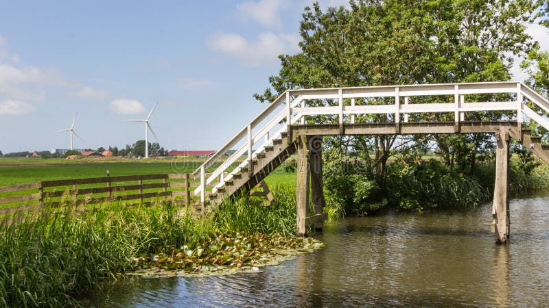 Typical Dutch Landscape with an Old Wooden Bridge and Modern Win Stock ...