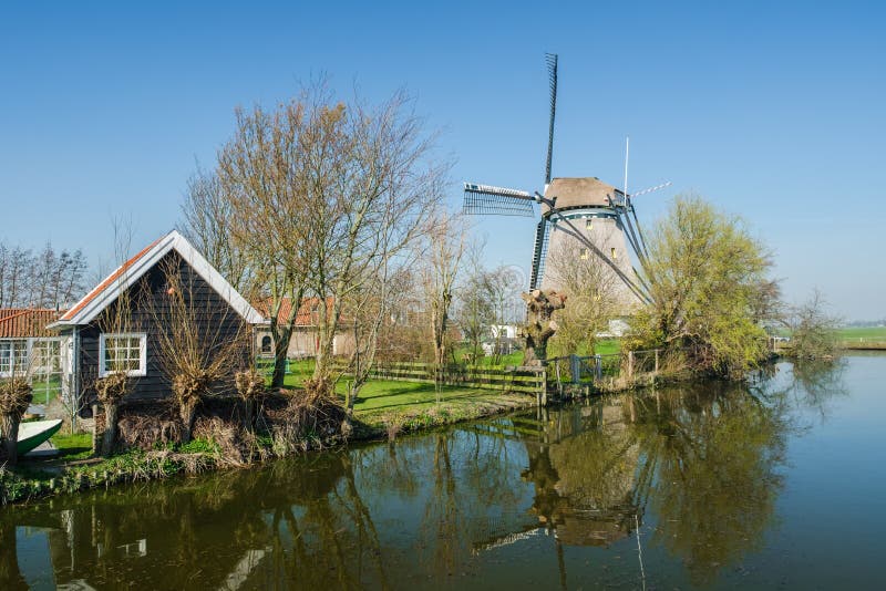 Typical Dutch Rural Scene with Farm and Windmill and Reflection in the ...