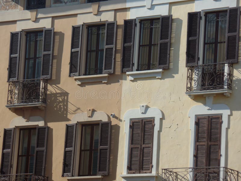 Typical Italian Style Building with Brown Shutters Stock Image - Image ...