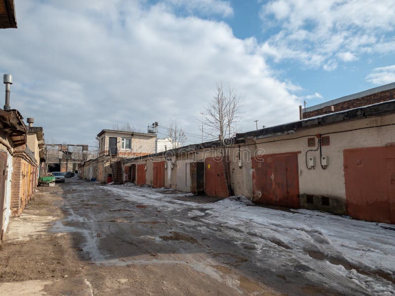 Row of Garage Boxes Under One Roof with Walls of White Brick with Brown ...
