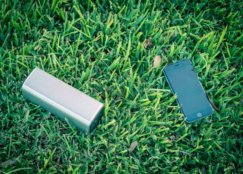 Typical Smart Phone and Bluetooth Speaker on Grass Lawn Nature ...