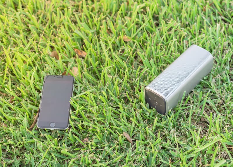 Typical Smart Phone and Bluetooth Speaker on Grass Lawn Nature ...