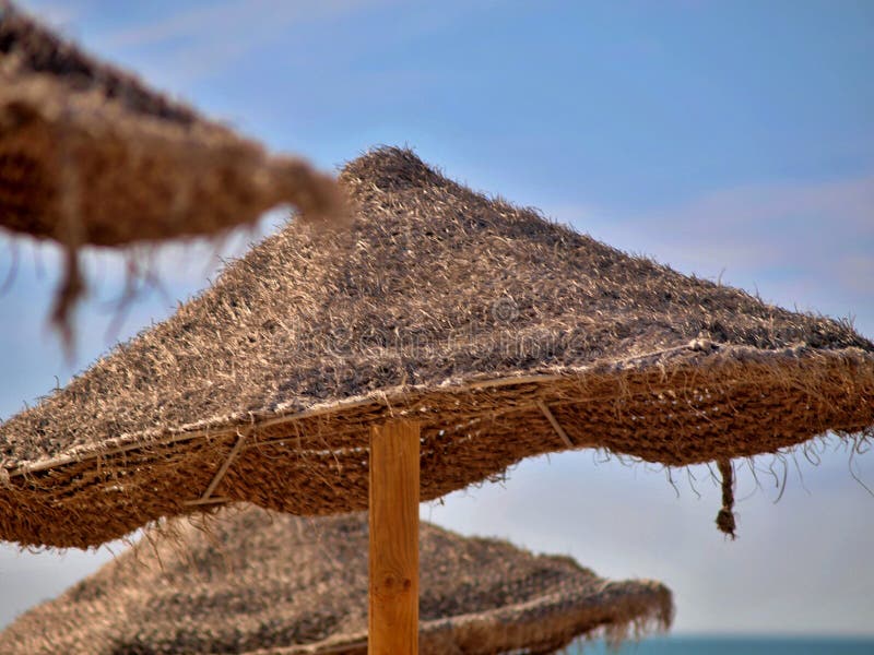Traditional Bast Sun Umbrellas in Front of Blue Sky Stock Photo - Image ...